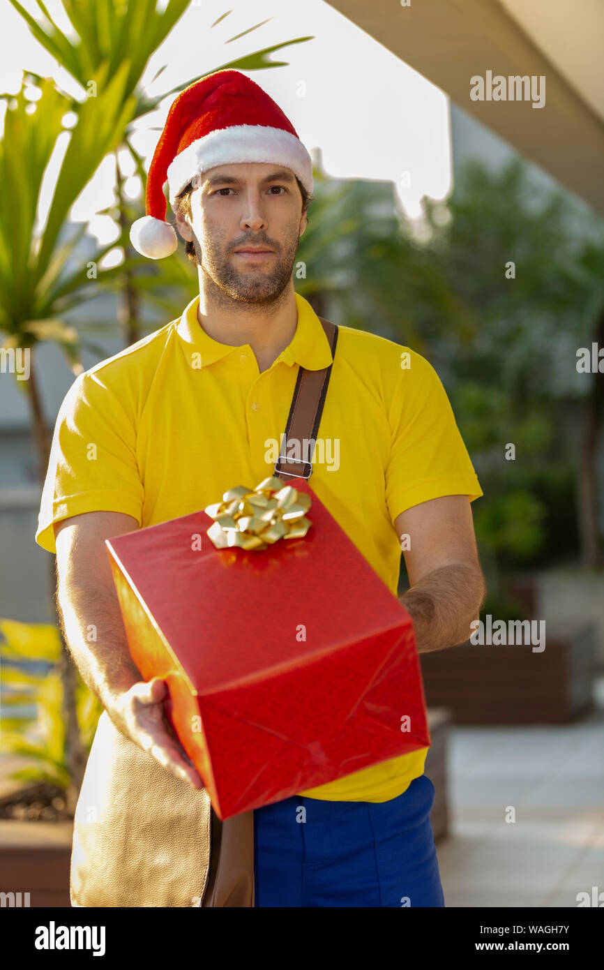 Brazilian mailman dressed as Santa Claus delivering a gift. Online ...