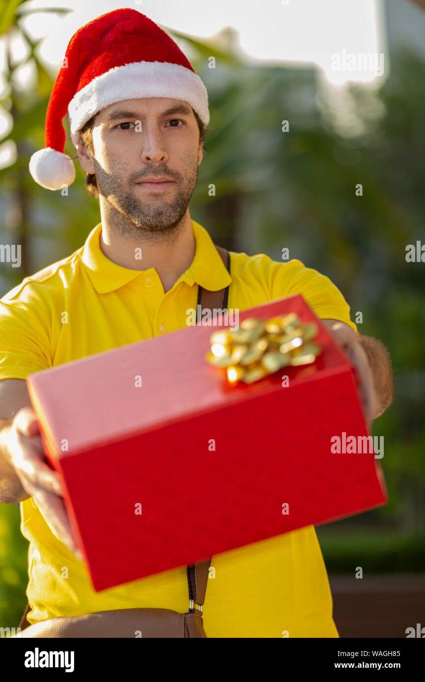 Brazilian mailman dressed as Santa Claus delivering a gift. Online ...