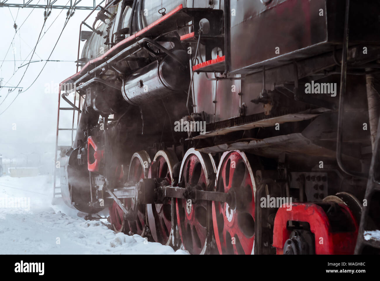 closeup of a steam locomotive wheels with valve gear and connecting ...