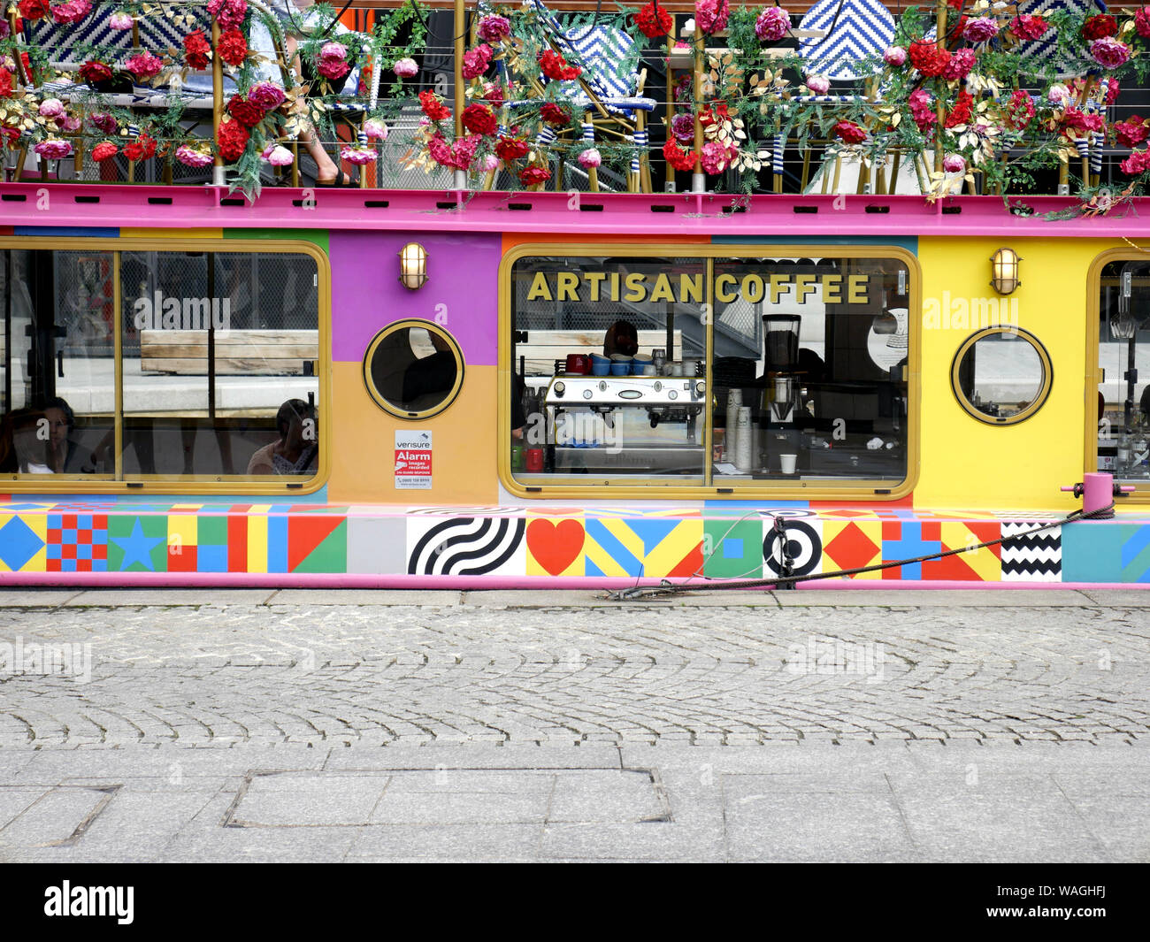 Fancy painted barge selling artisan coffee moored on the towpath at ...