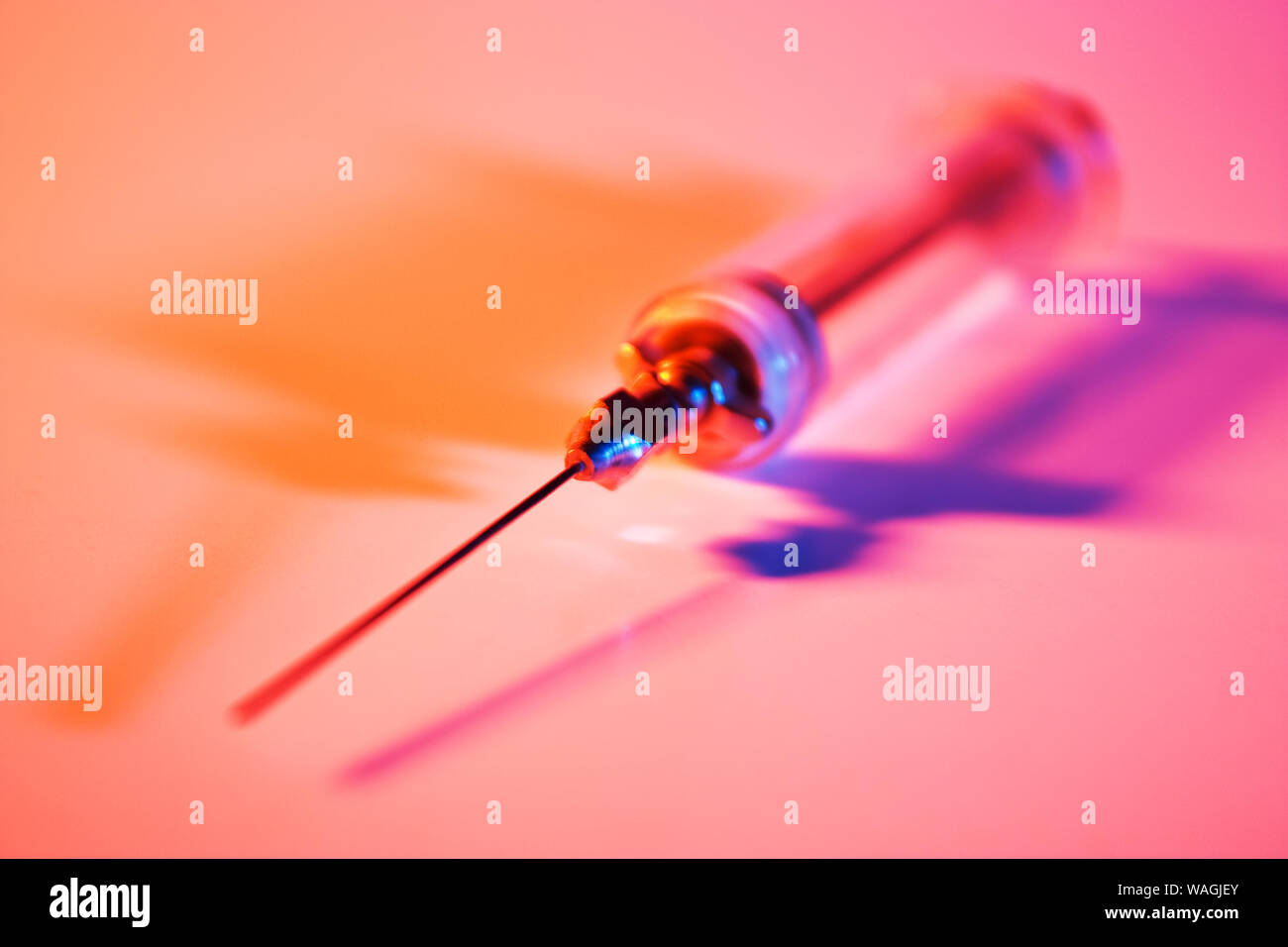 old glass syringe multicolored lights Stock Photo - Alamy
