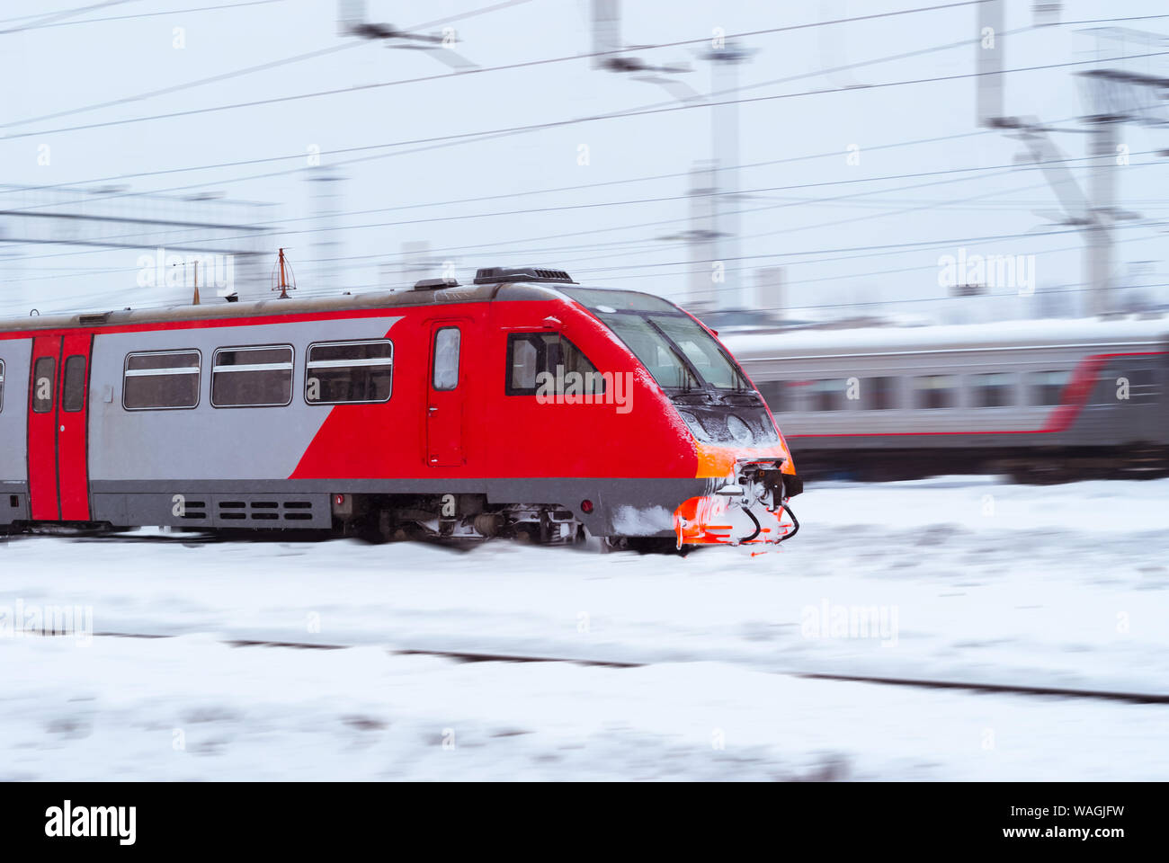 ice-covered diesel multiple unit train rushes along a blurred winter ...