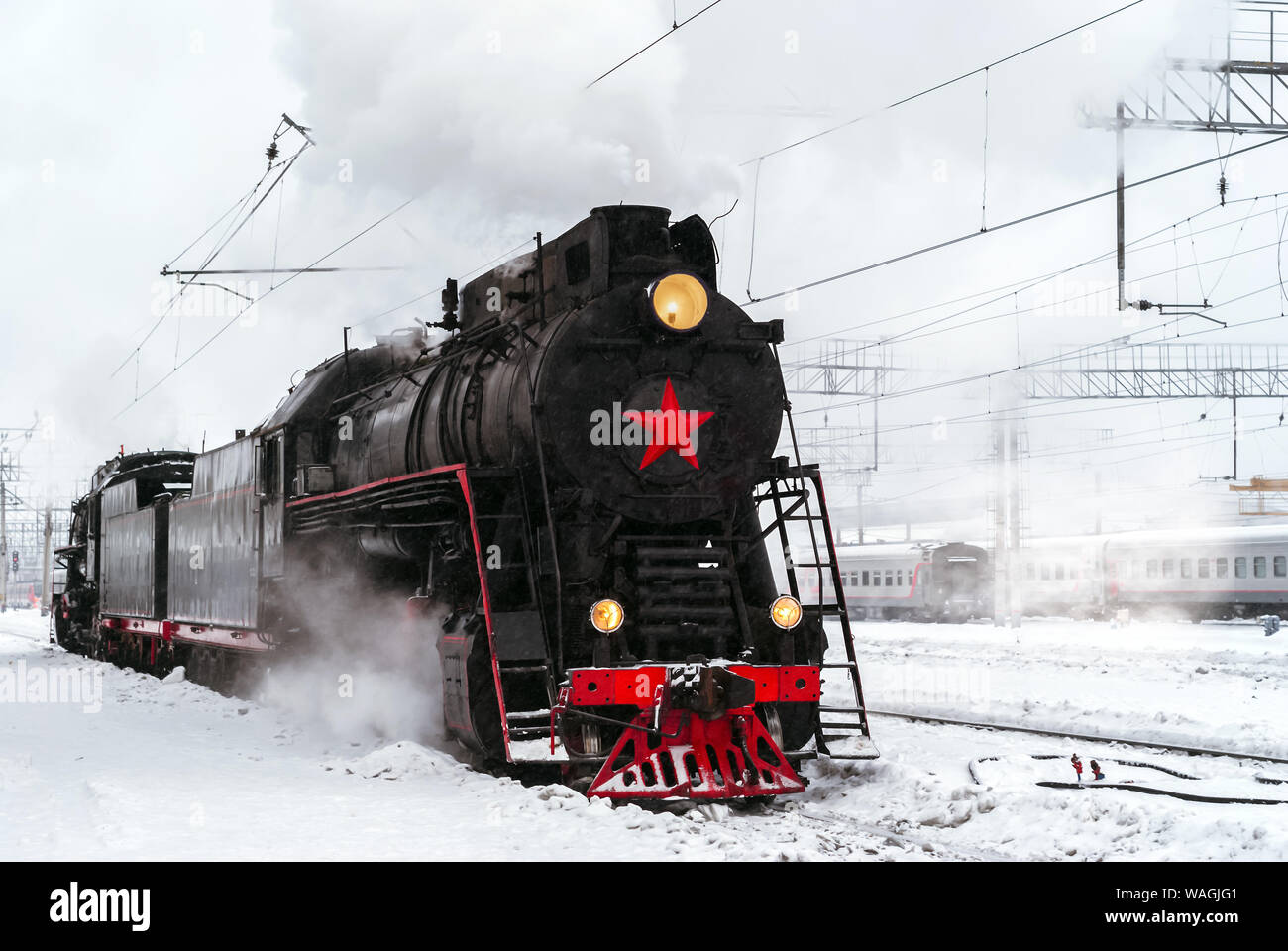 steam locomotive arrives at the railway junction in winter Stock Photo ...