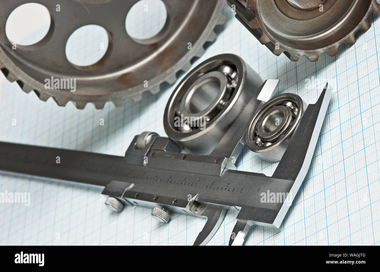 caliper with gears and bearings on graph paper Stock Photo - Alamy
