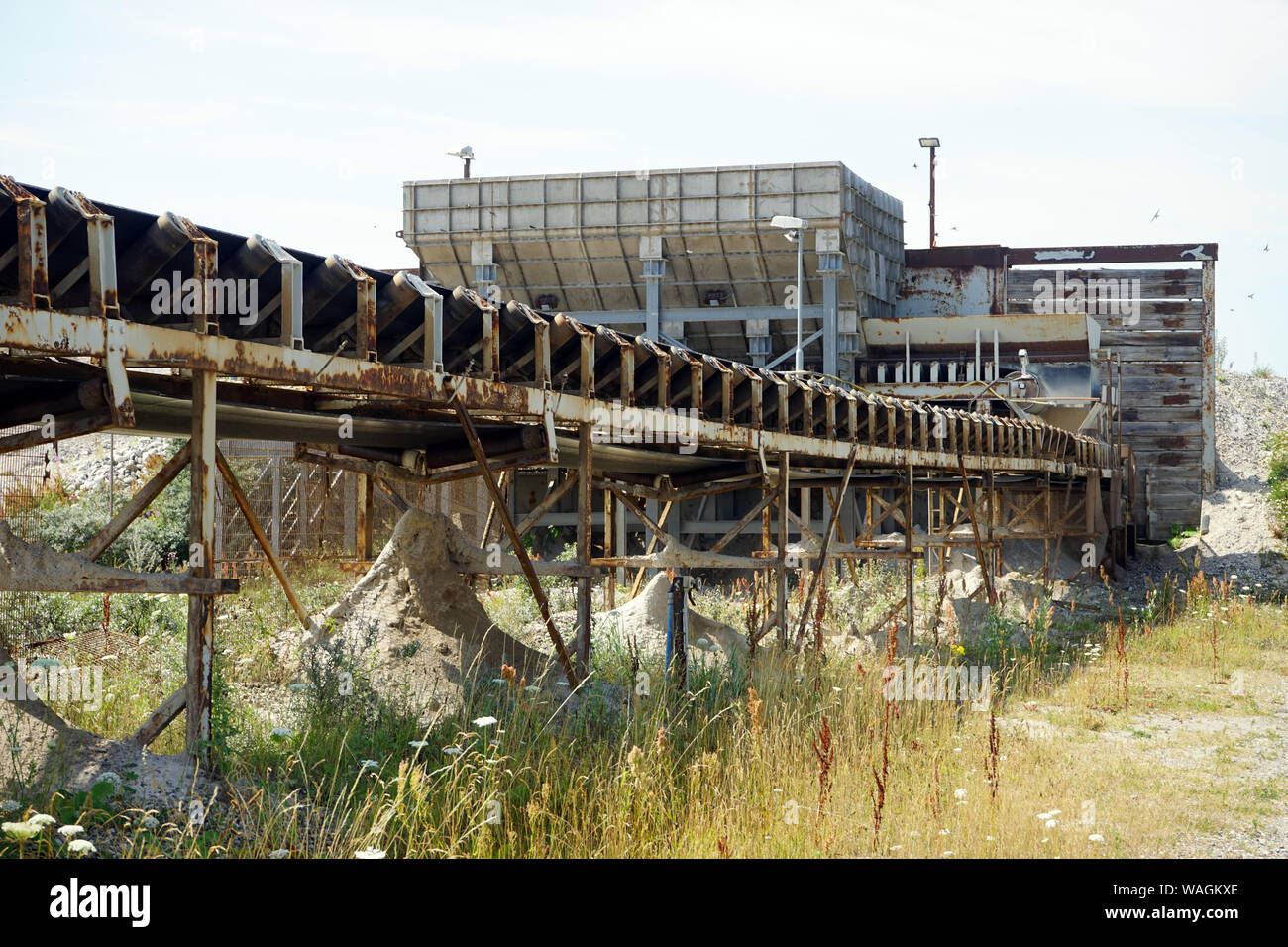 Big rusty conveyor and quarry Stock Photo - Alamy