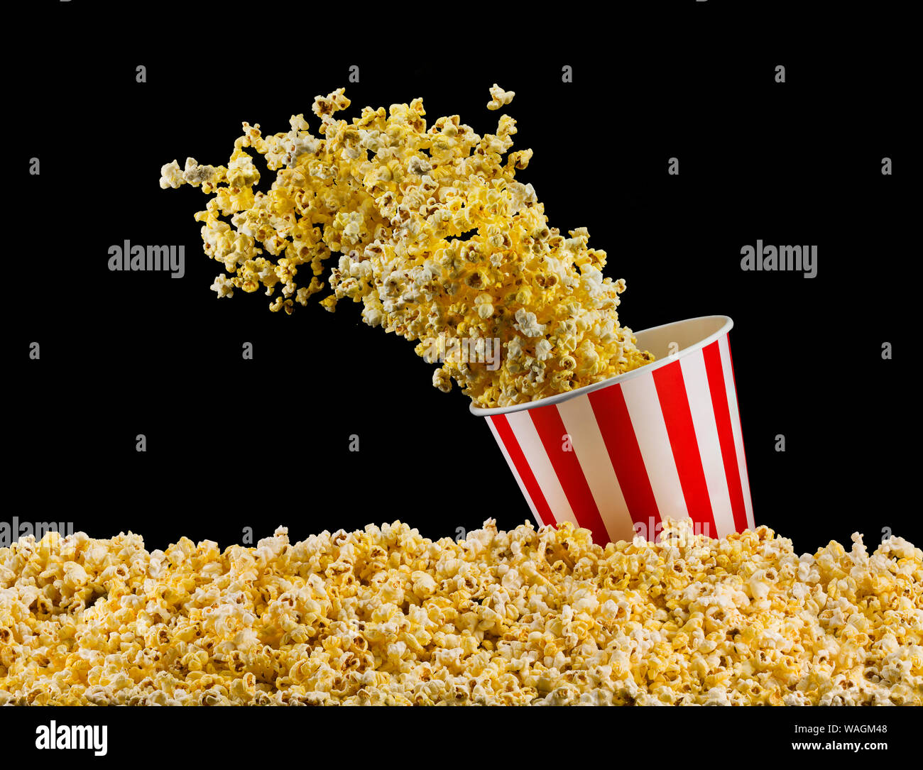 Flying popcorn from striped bucket isolated on black background Stock ...