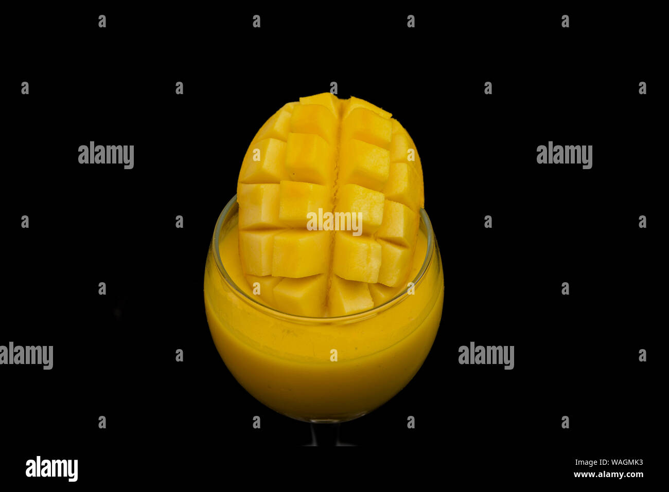Mango fruit slice shake close up on black background Stock Photo - Alamy