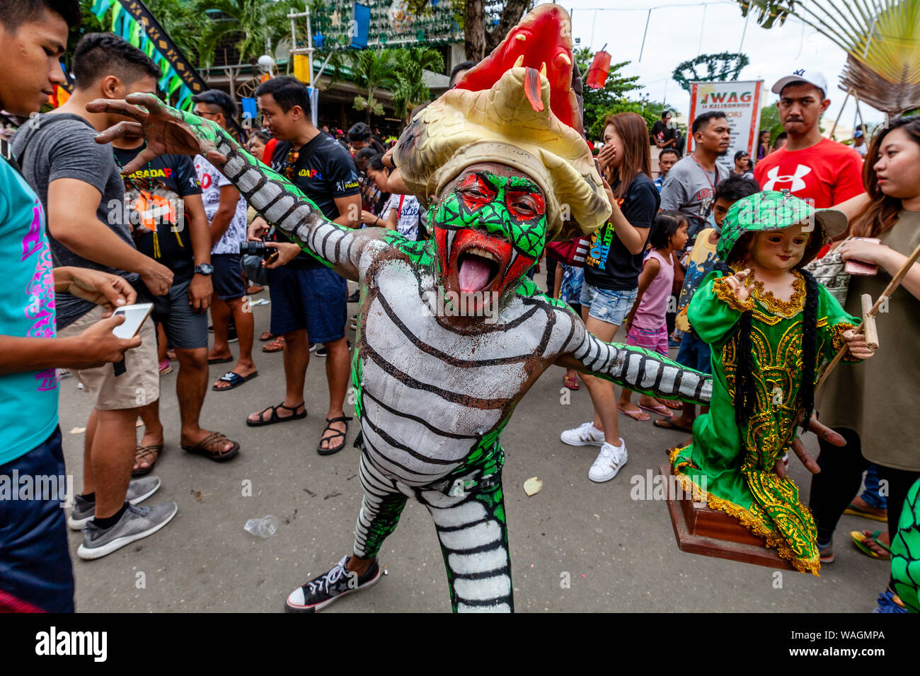 People In Colourful Costumes Holding Santo Nino Statues Parade Through ...