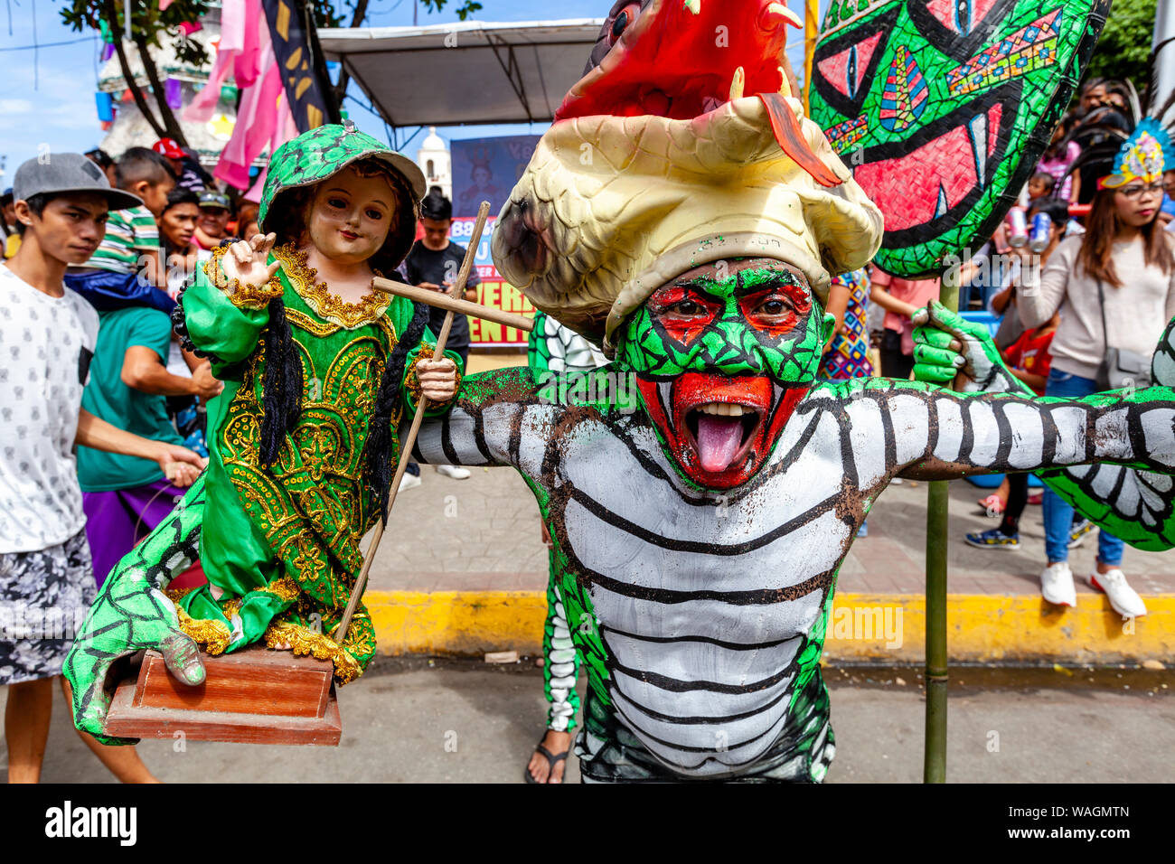 People In Colourful Costumes Holding Santo Nino Statues Parade Through ...