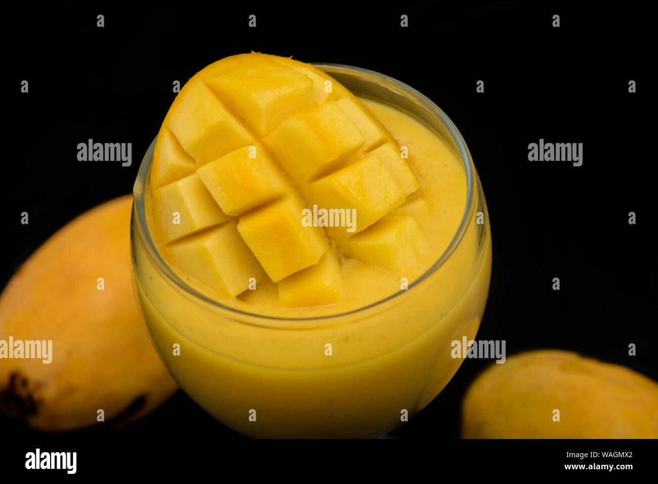 Mango fruit slice shake close up on black background Stock Photo - Alamy