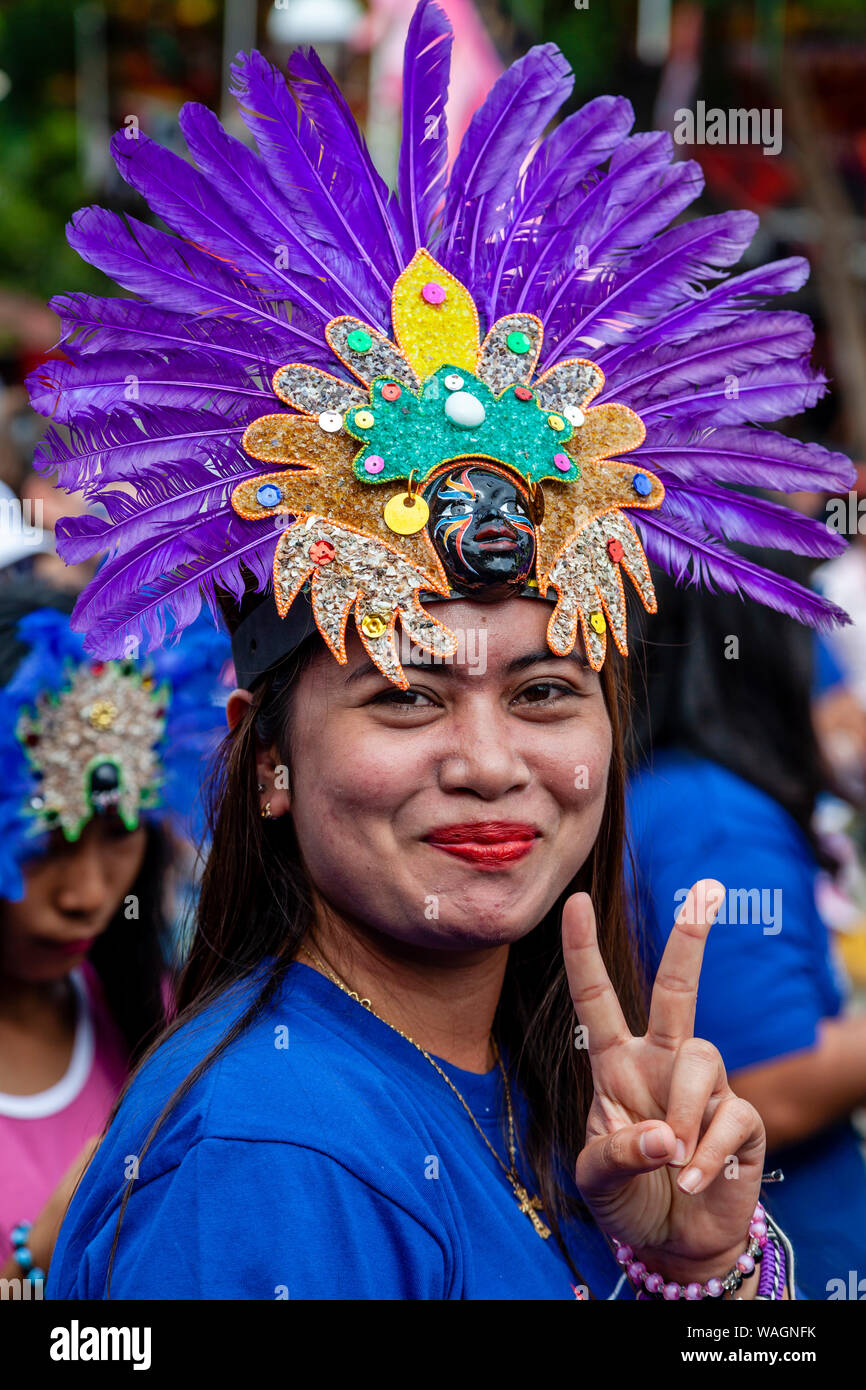 A Filipino Woman Takes Part In A Street Procession During The Ati ...