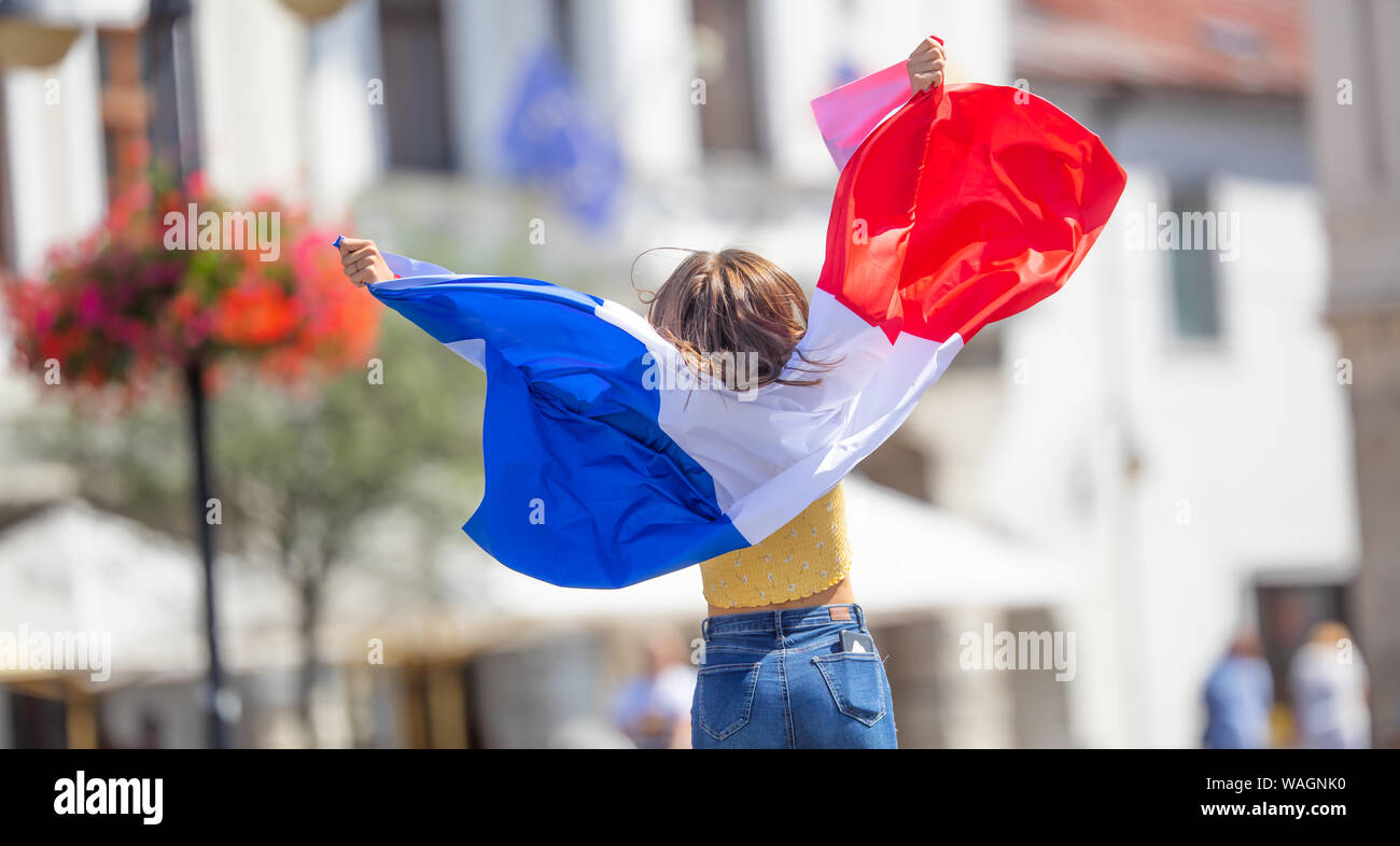 Attractive happy young girl with the France flag Stock Photo - Alamy