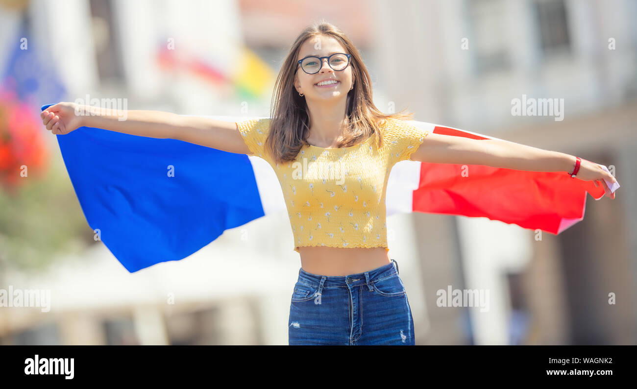 Attractive happy young girl with the France flag Stock Photo - Alamy