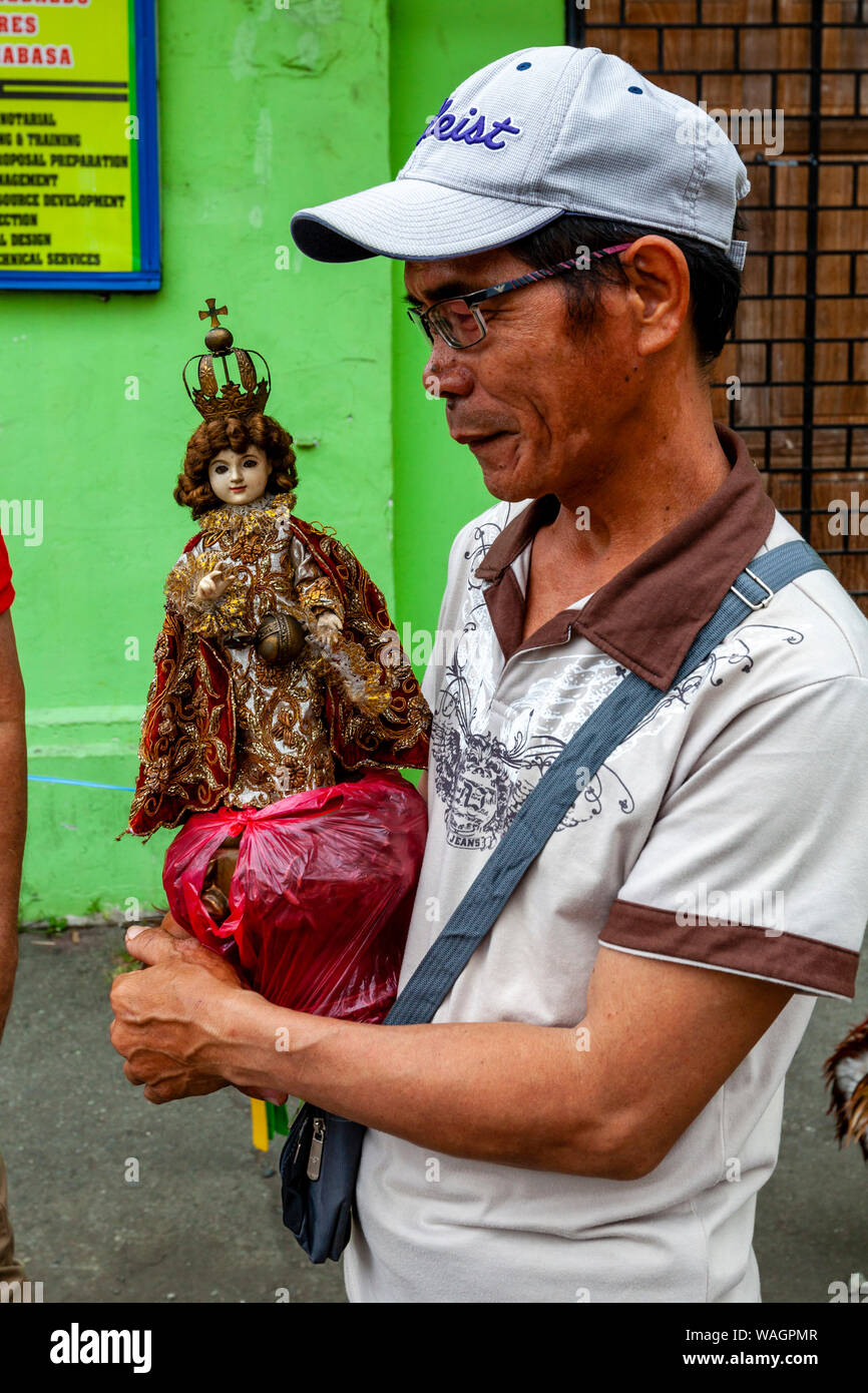 Local People Parade Their Santo Nino Statues Around The Streets Of ...