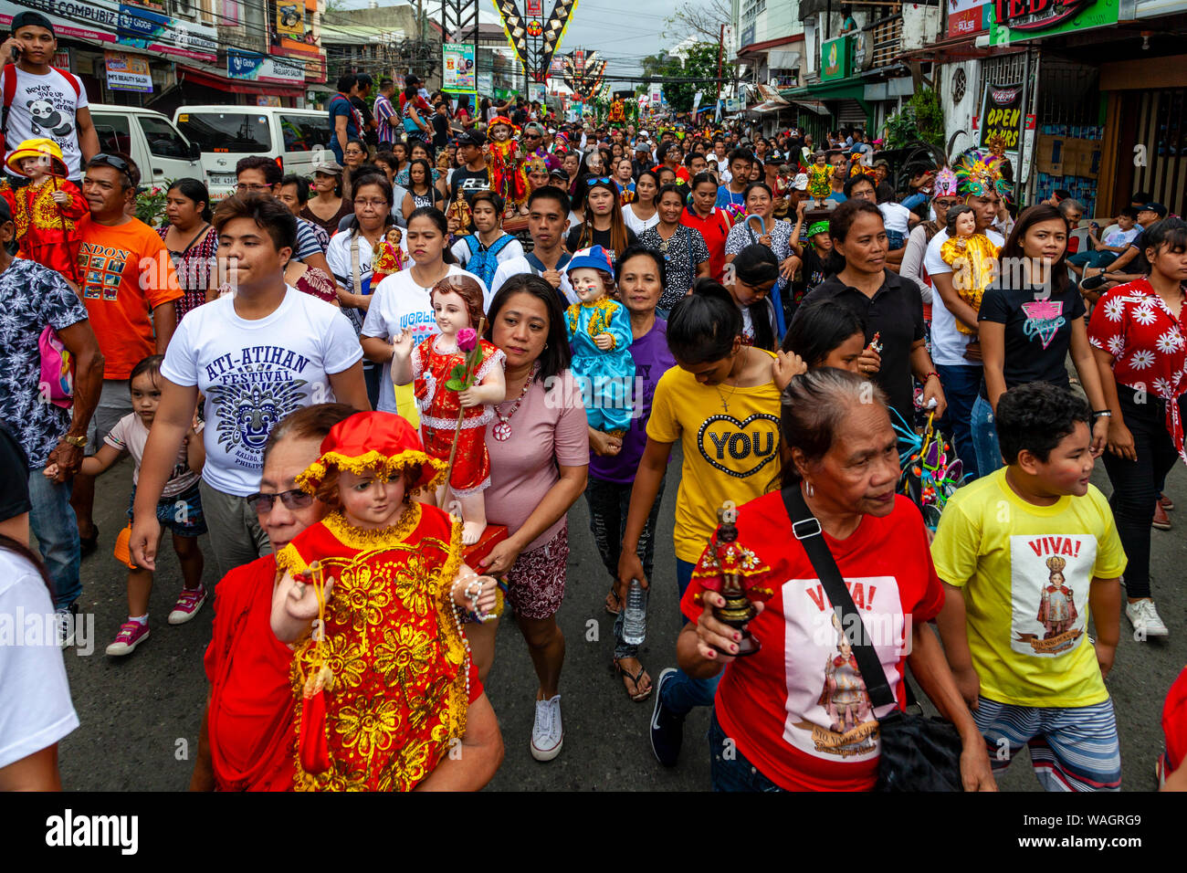Filipinos Walk Through The Streets Carrying Statues Of Santo Nino ...