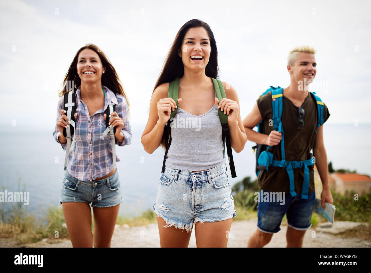 Group of friends backpackers walking and traveling outdoor Stock Photo ...