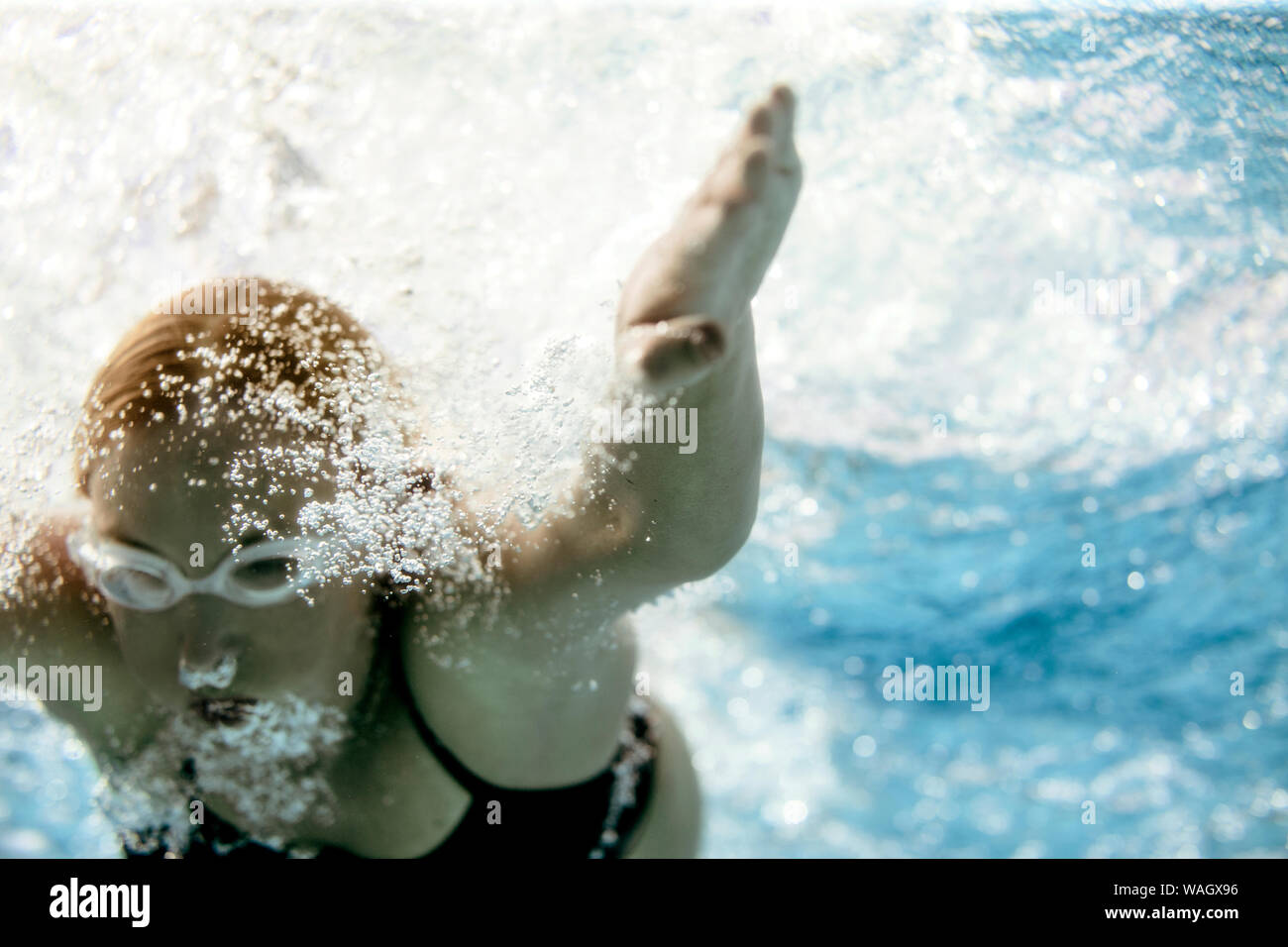 Female swimmer diving underwater Stock Photo - Alamy