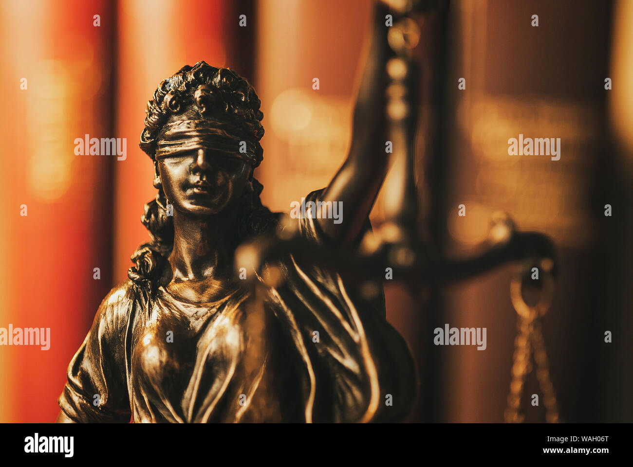 Brass figure of Justice wearing a blindfold holding up scales symbolic ...