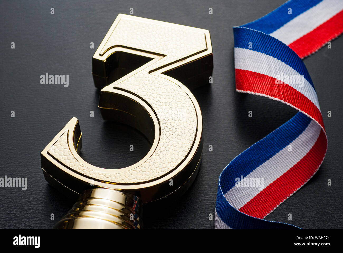 3rd place runner up gold trophy or award with a textured number three ...