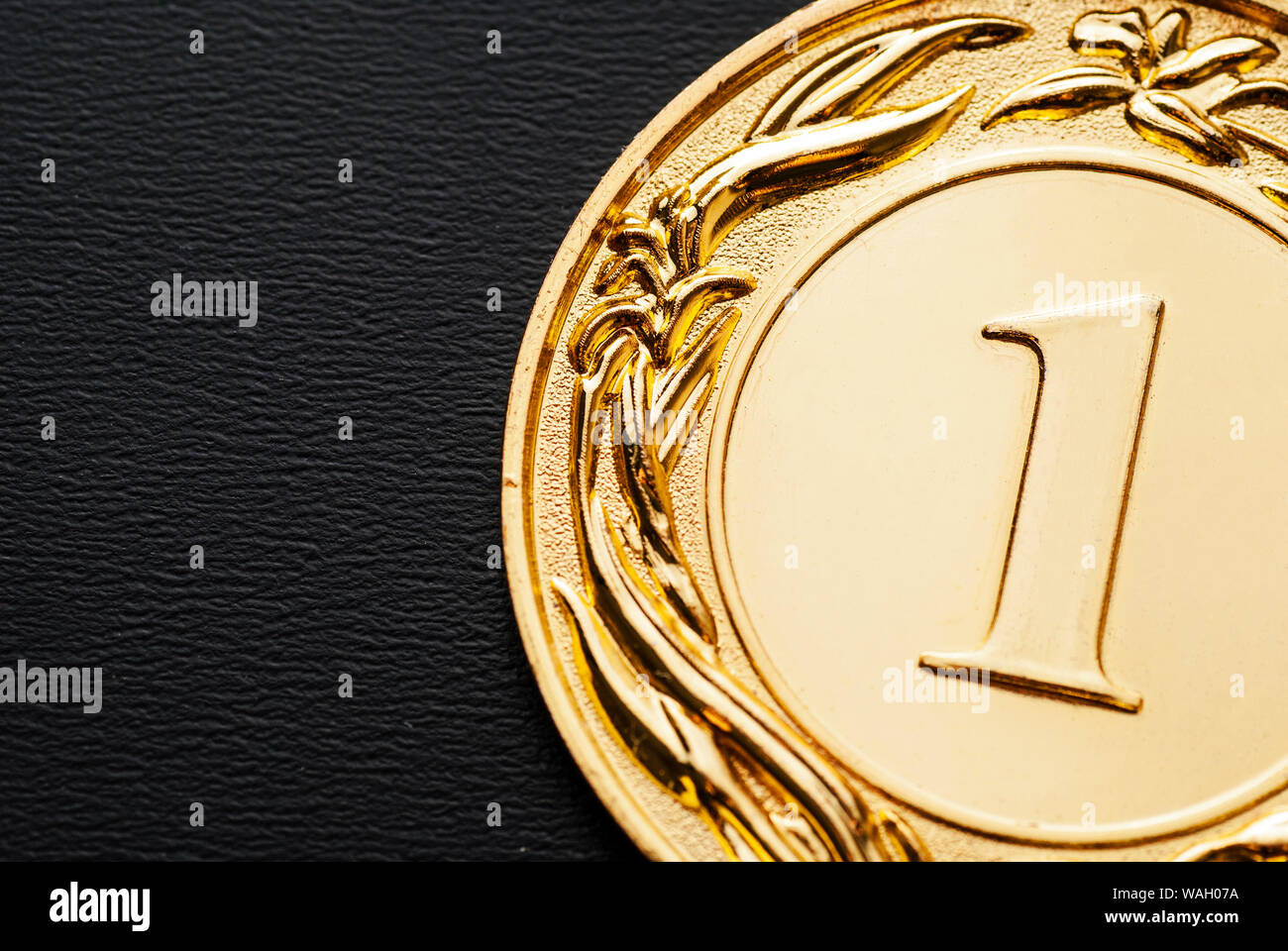 Close-up of a golden medal for the number one champion as award and ...