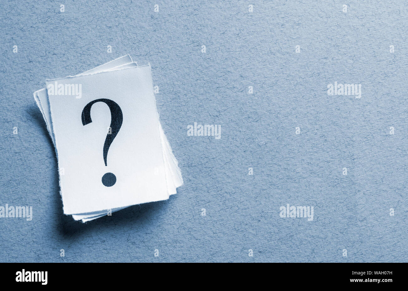 Stack of question marks printed on paper arranged to the side on a ...