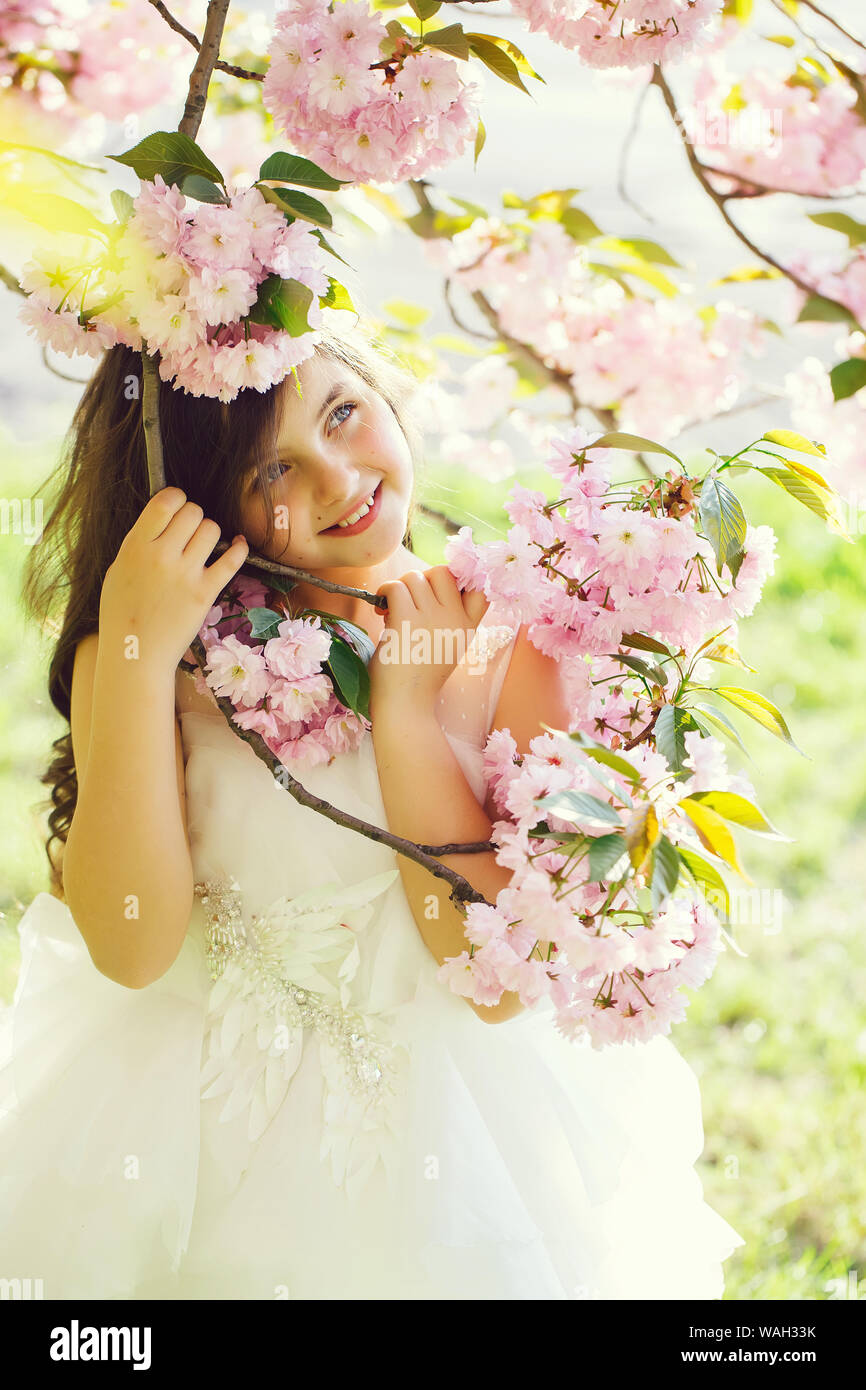 Little girl in spring bloom Stock Photo - Alamy