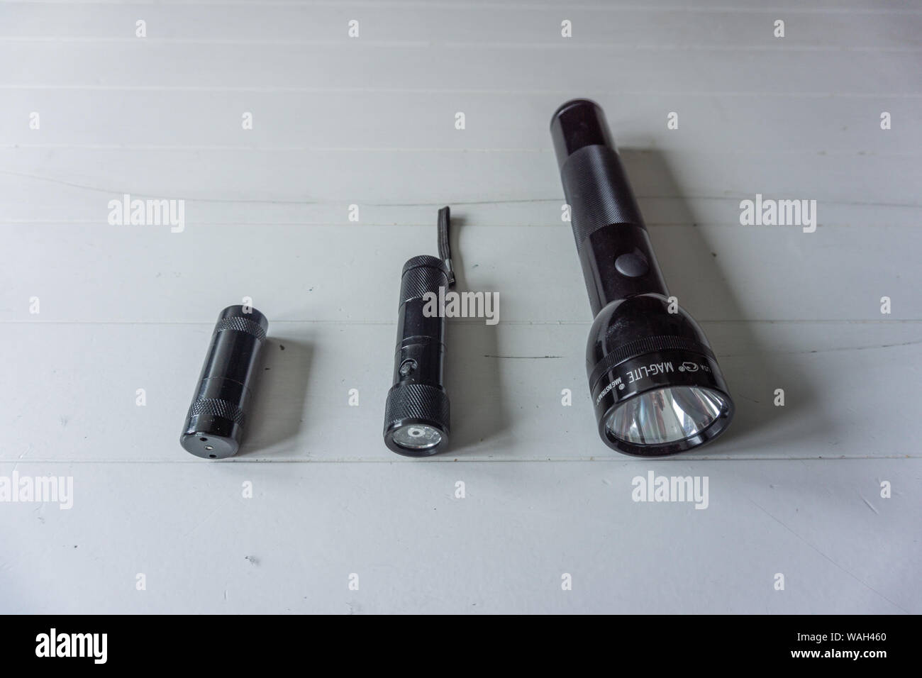 Flashlights arranged on size on white background Stock Photo - Alamy