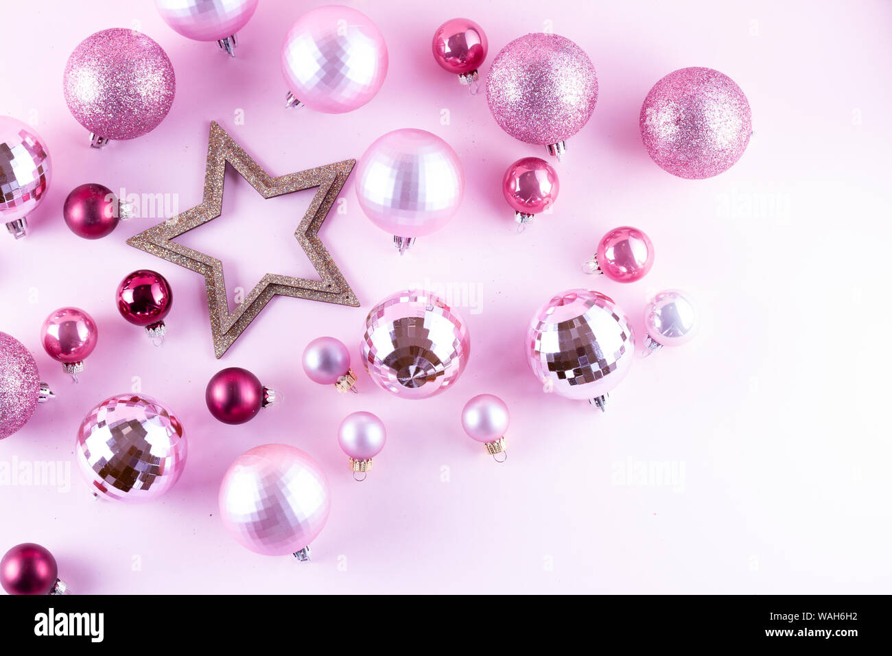 Christmas pink balls and star decorations on pink background Stock ...