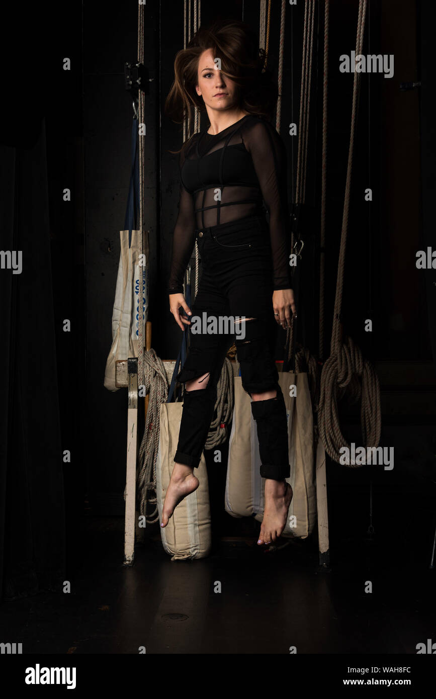 A young woman in a black costume dances backstage in a theater Stock ...