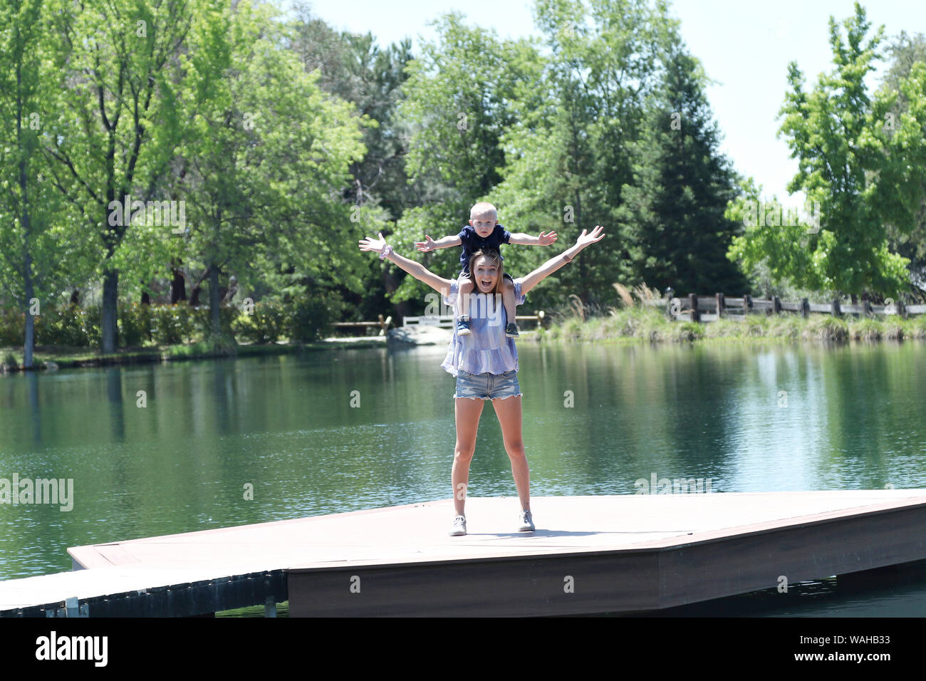 Kids having fun and playing in a rural pond Stock Photo - Alamy
