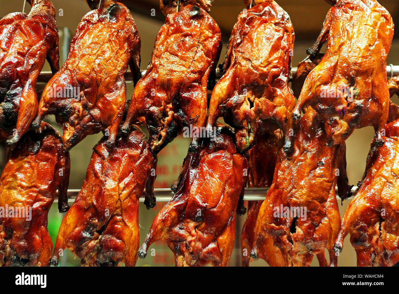 Crispy fried ducks hang at Chinese restaurant Stock Photo - Alamy