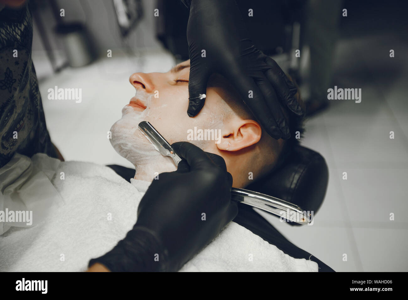 The man cuts his beard in the barbershop Stock Photo - Alamy