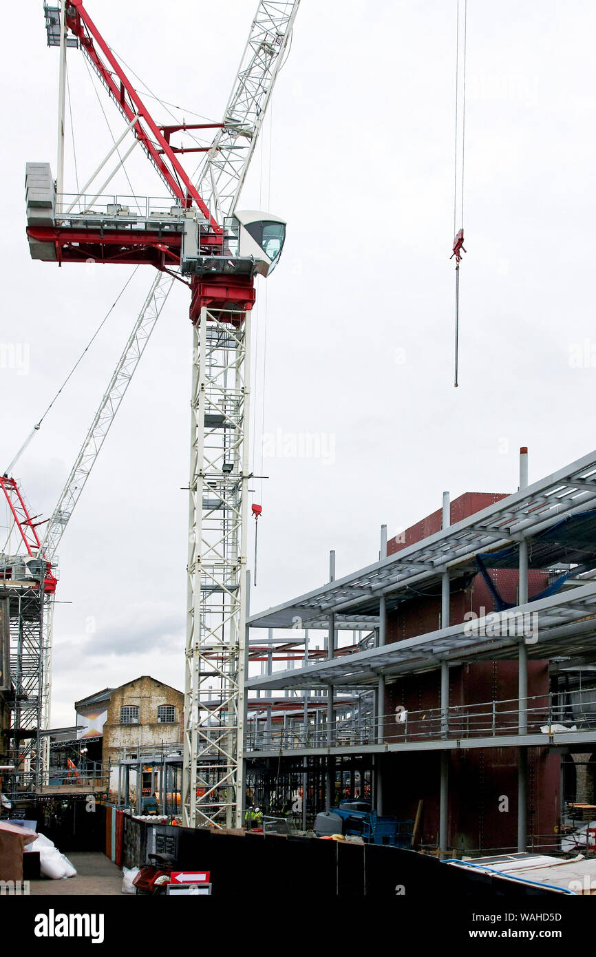 New building construction site with tall crane Stock Photo - Alamy