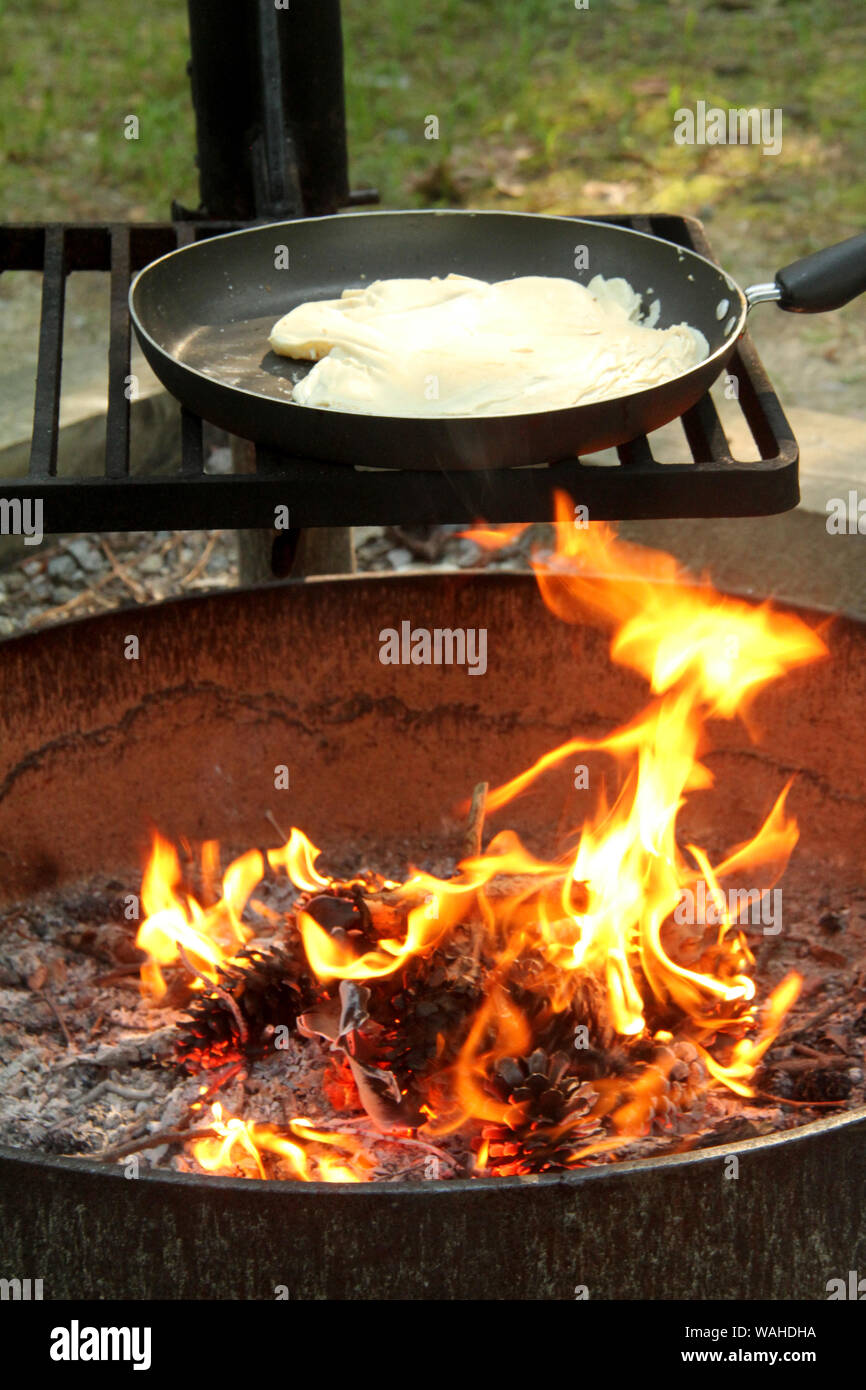 Food cooked over an open fire while camping Stock Photo - Alamy