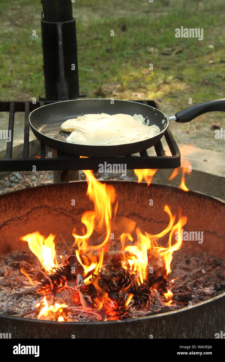 Food cooked over an open fire while camping Stock Photo - Alamy