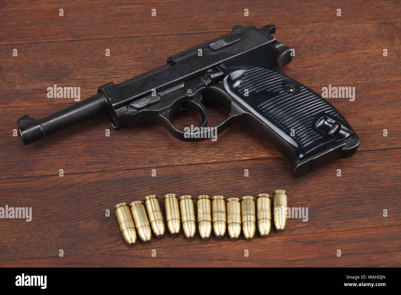 WWII era nazi german army handgun with ammunitions on wooden table ...