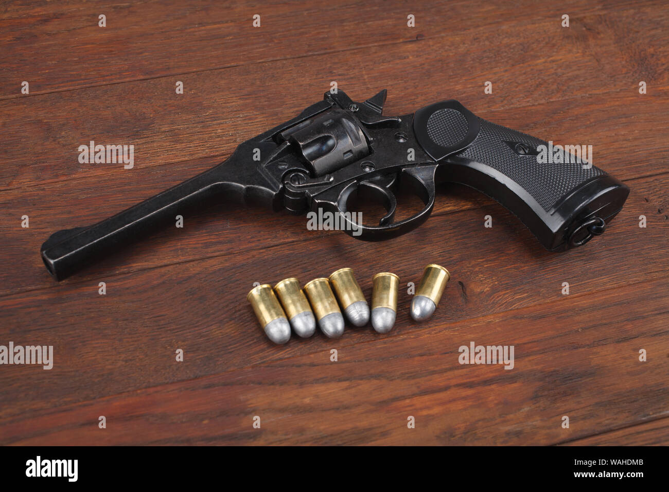 WW2 period British Army Revolver with ammunitions on wooden table Stock ...