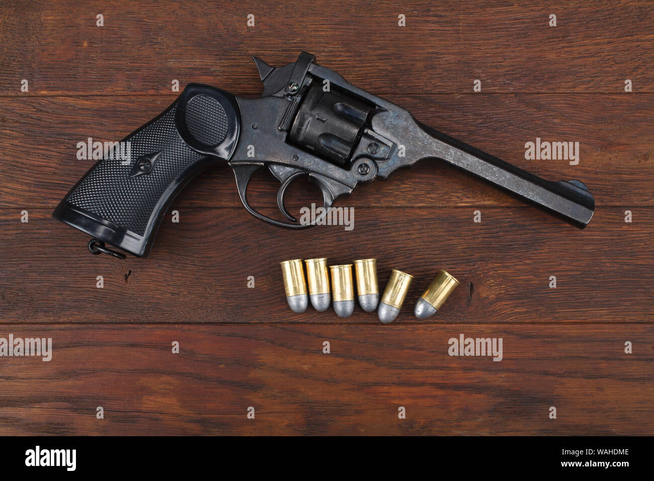 WW2 period British Army Revolver with ammunitions on wooden table Stock ...