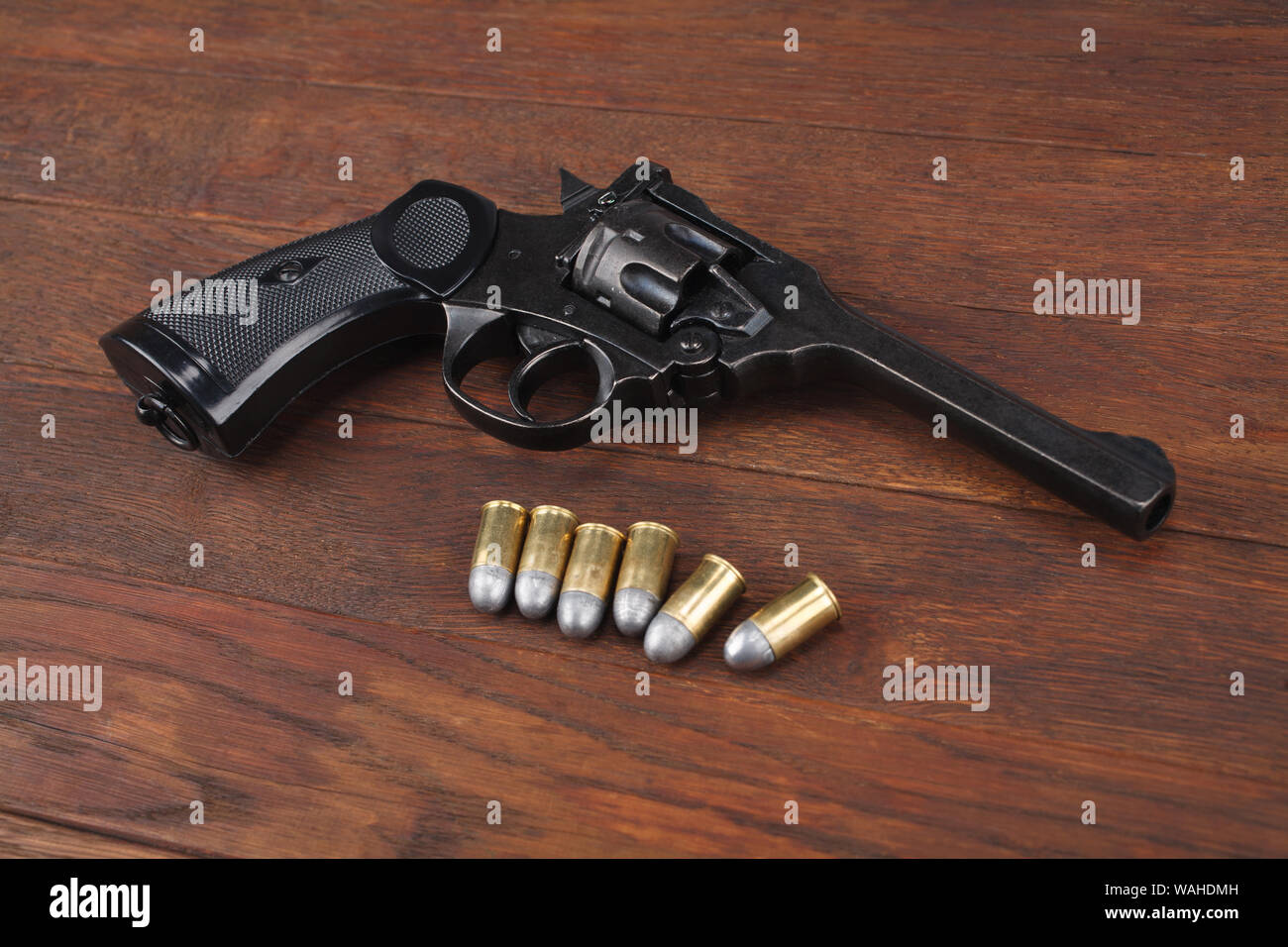 WW2 period British Army Revolver with ammunitions on wooden table Stock ...