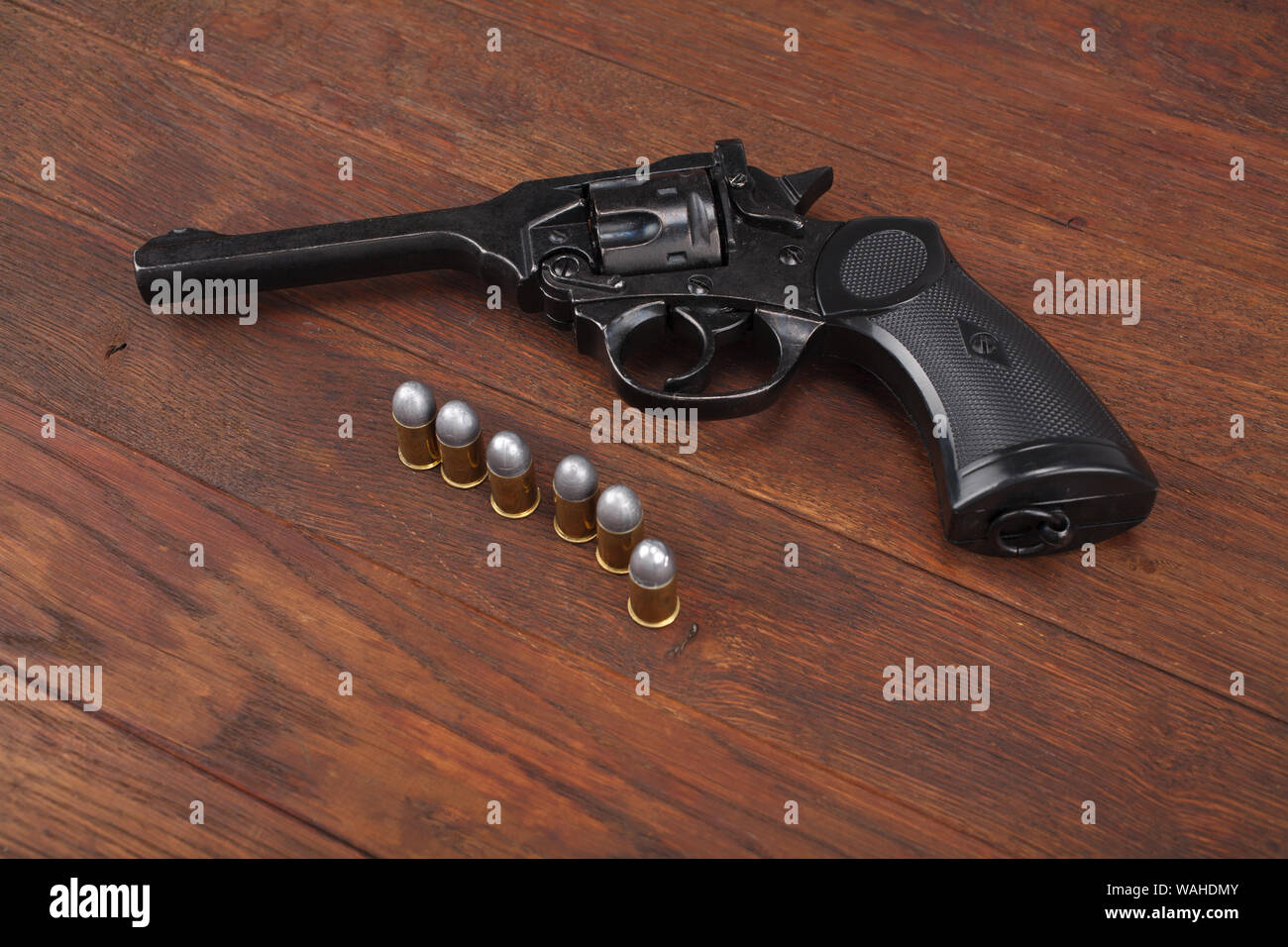 WW2 period British Army Revolver with ammunitions on wooden table Stock ...