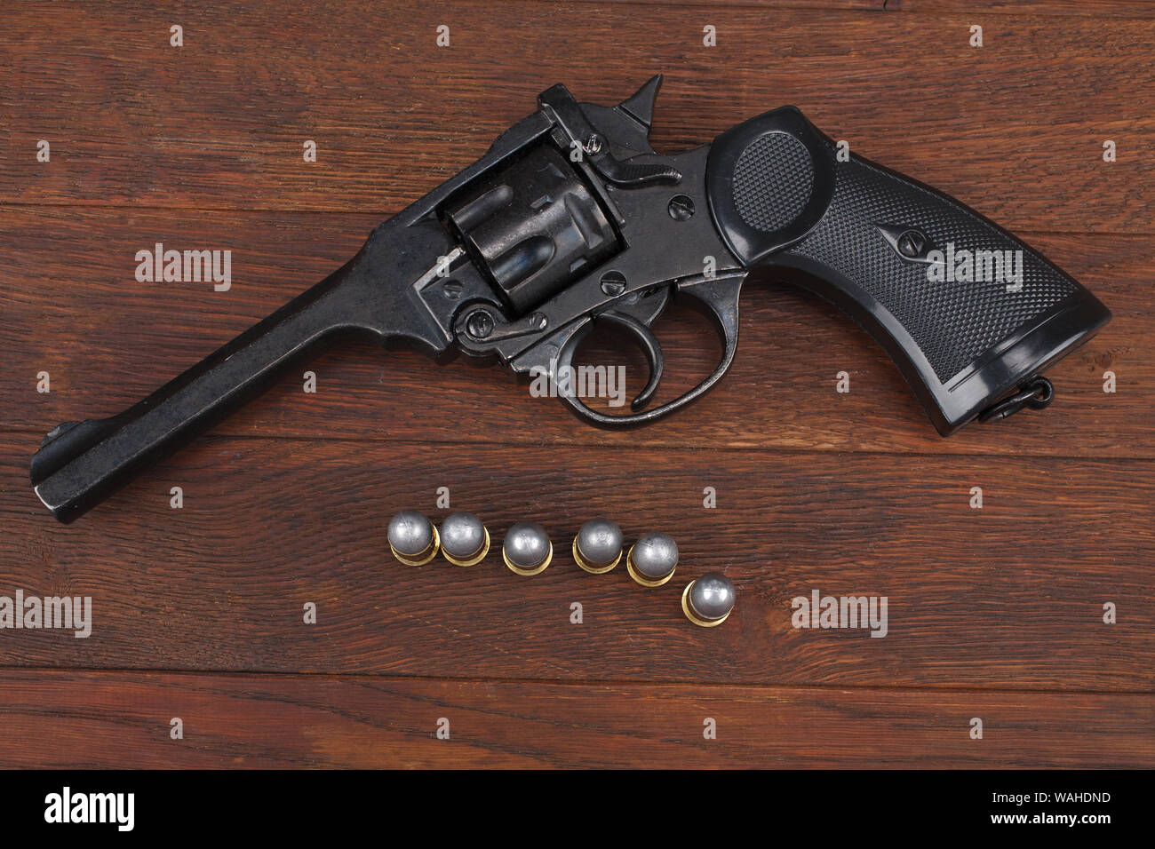 WW2 period British Army Revolver with ammunitions on wooden table Stock ...