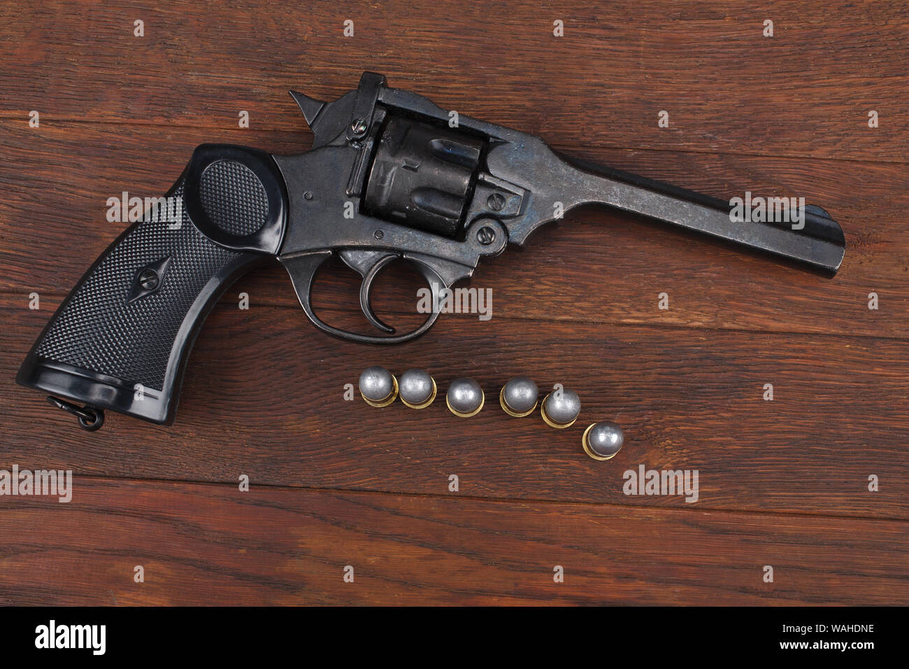 WW2 period British Army Revolver with ammunitions on wooden table Stock ...