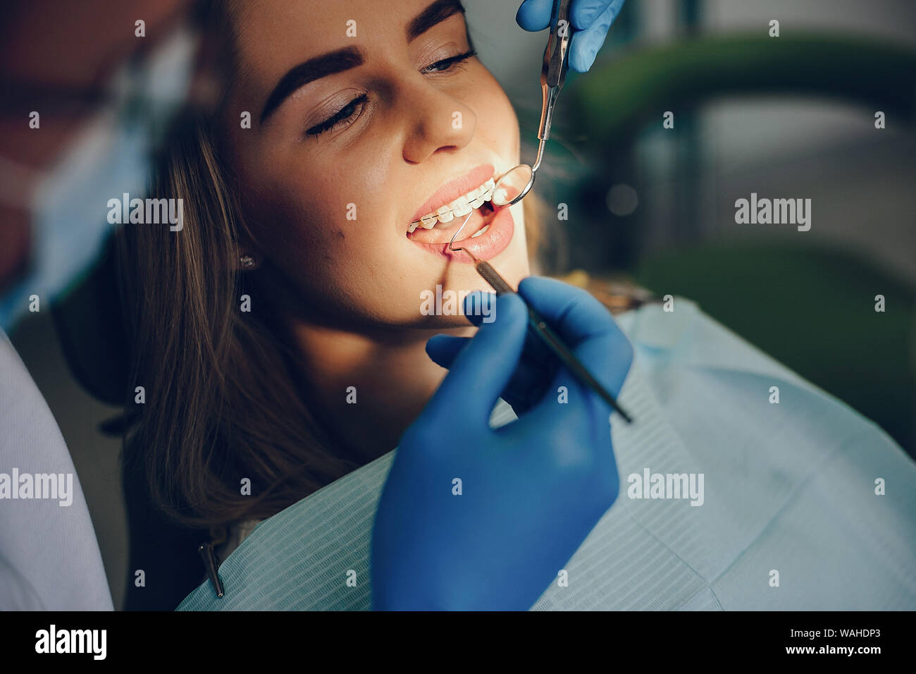 Beautiful girl sitting in the dentist's office Stock Photo - Alamy