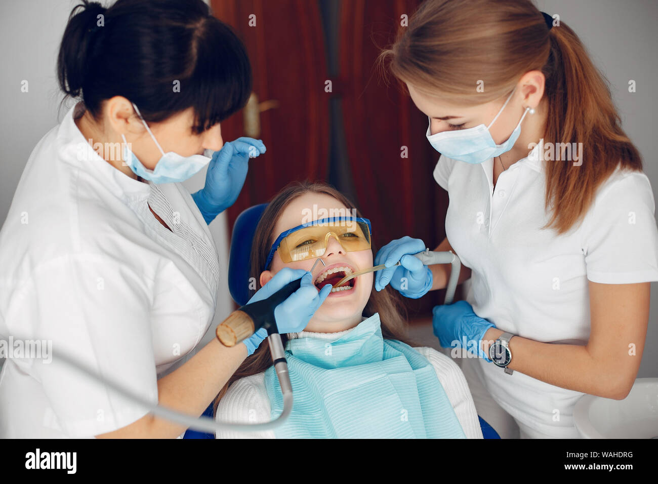 Beautiful girl sitting in the dentist's office Stock Photo - Alamy