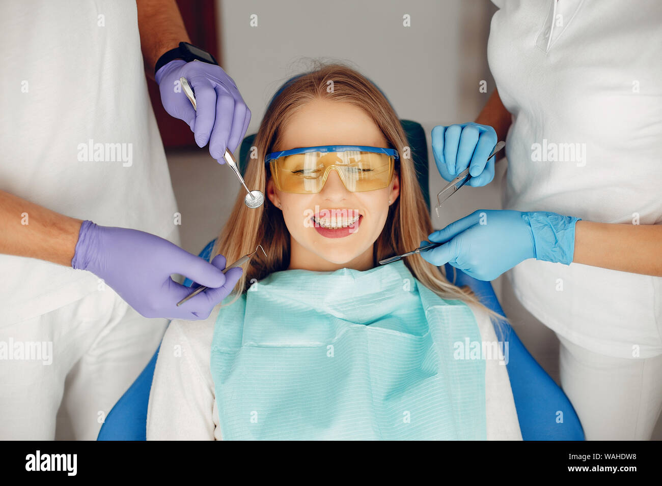 Beautiful girl sitting in the dentist's office Stock Photo - Alamy
