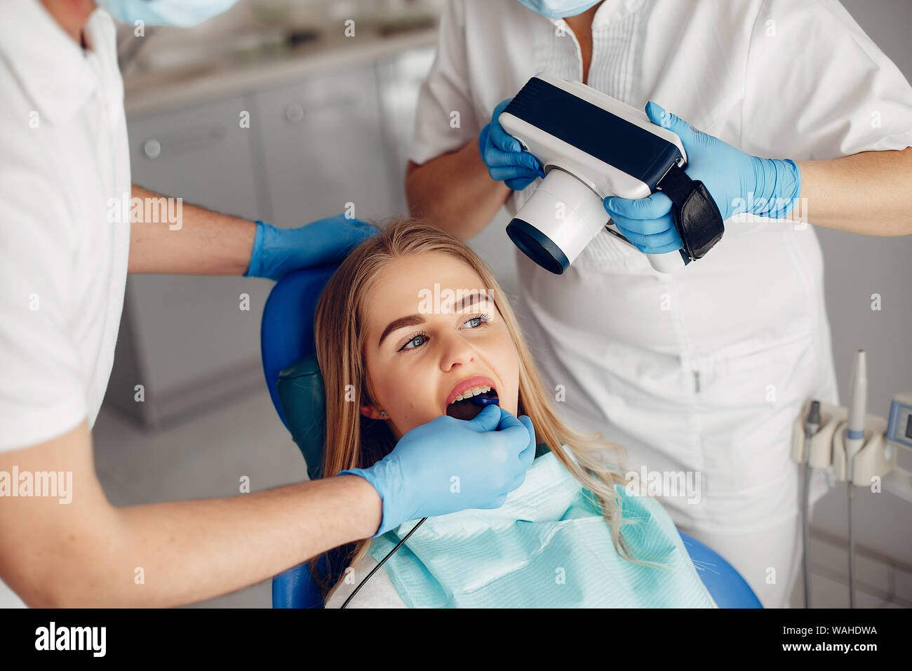 Beautiful girl sitting in the dentist's office Stock Photo - Alamy
