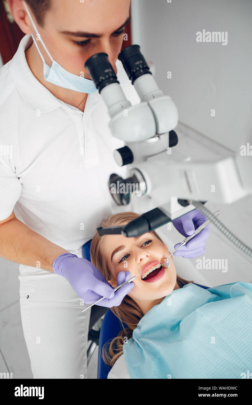 Beautiful girl sitting in the dentist's office Stock Photo - Alamy
