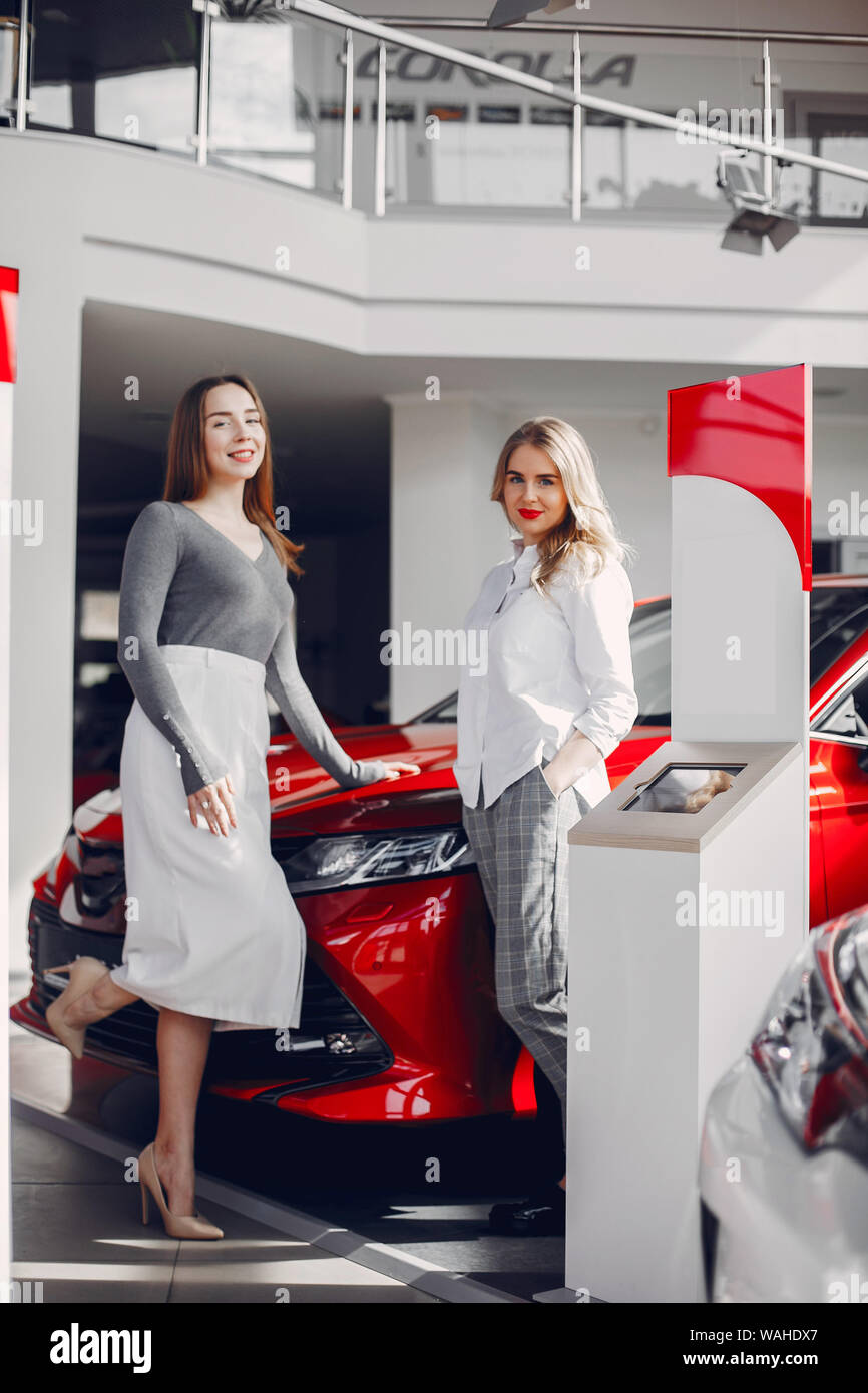 Two stylish women in a car salon Stock Photo - Alamy