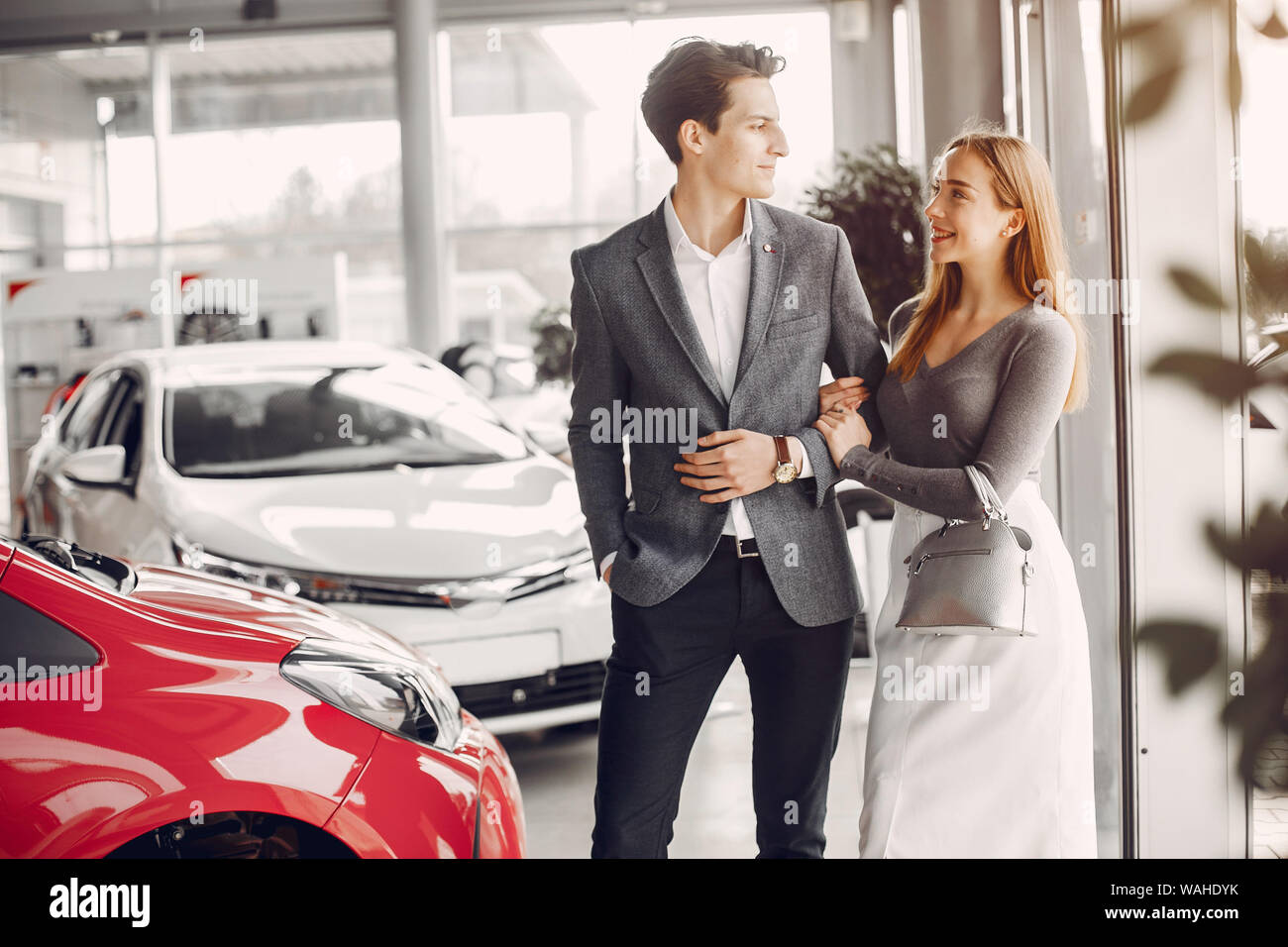 Elegant couple in a car salon Stock Photo - Alamy