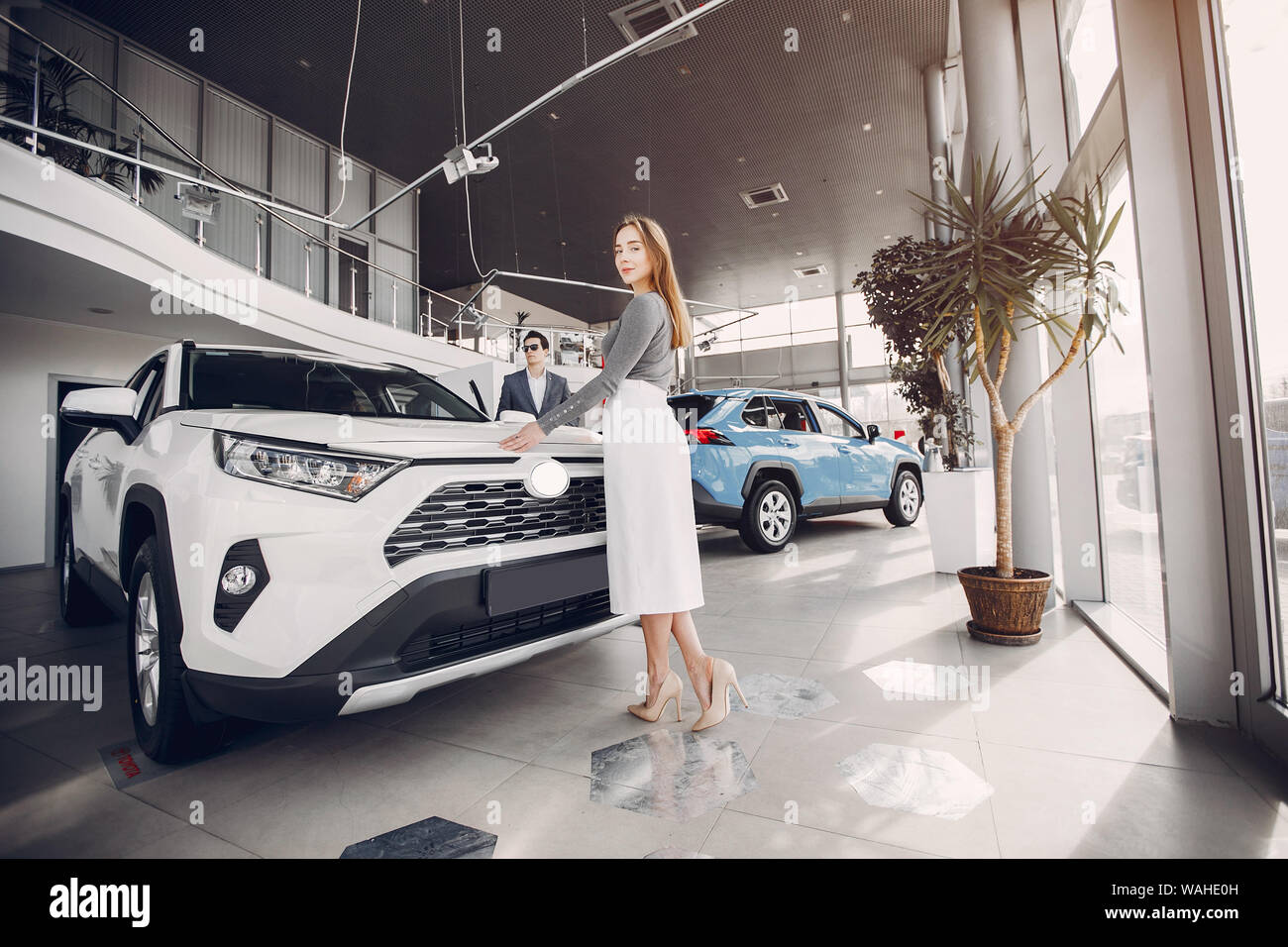 Elegant couple in a car salon Stock Photo - Alamy